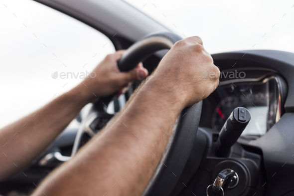 young man hands driving a car with both hands on the wheel Stock Photo ...