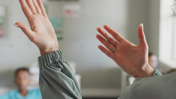 Video of hands of caucasian female teacher explaining lesson to class ...