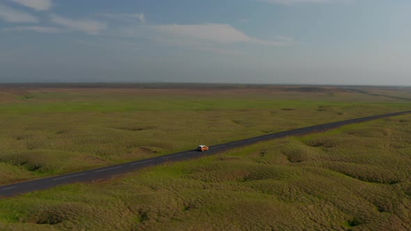 Aerial Footage of Car Driving on Road in Flat Landscape, Stock Footage