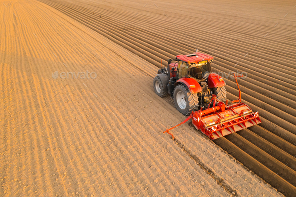 Contemporary tractor drags plug making furrows on soil Stock Photo by ...