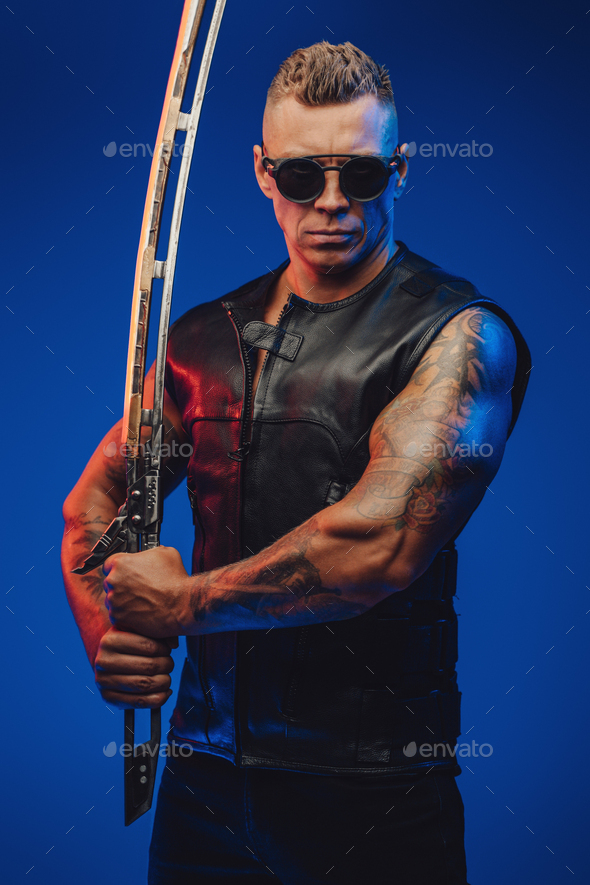 Muscular guy in cyberpunk style with sword against blue background ...