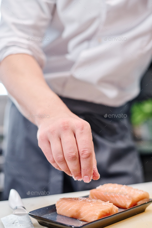 Chef salting salmon fish in kitchen Stock Photo by AnnaStills | PhotoDune