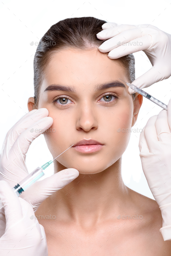 Portrait of attractive woman getting botox injection isolated on white ...