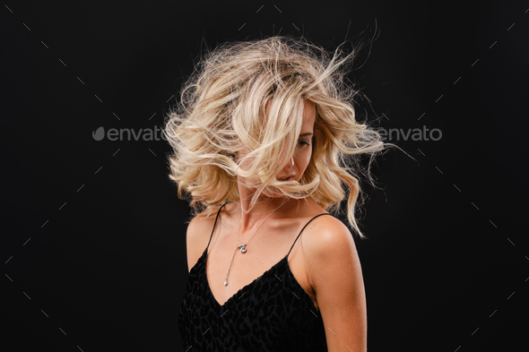 Low key photo of young happy woman with flowing hair Stock Photo by ...