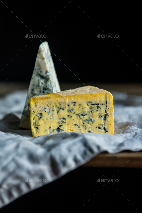 traditional yellow and white cheese with mold on a table Stock Photo by ...