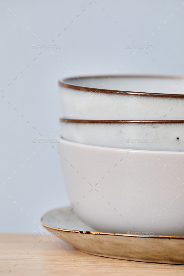 Stack of ceramic bowls on plate Stock Photo by seventyfourimages ...