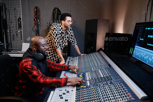 Producer And Singer Working Together Stock Photo by Pressmaster | PhotoDune