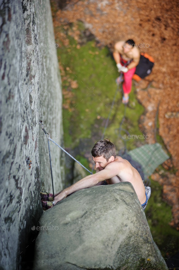 Muscular rock climber climbs on cliff wall with rope Stock Photo by ...