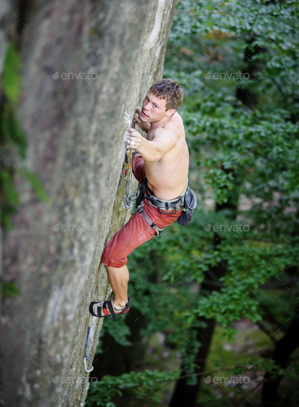 Muscular rock climber climbs on overhanging cliff Stock Photo by ...