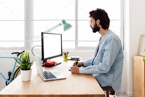 Professional designer using a graphic tablet and a computer while ...