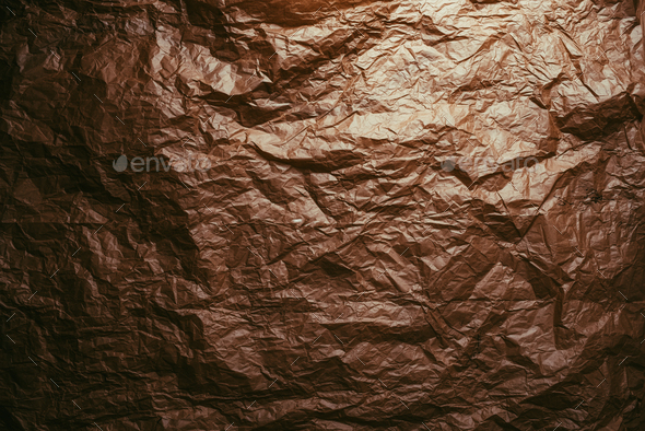 Crumpled and expanded paper with natural texture of reddish tones ...
