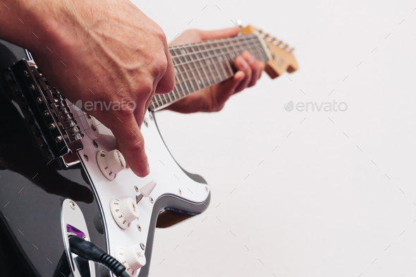 Guitarist playing musical instruments (focus on hand). pop, heavy, folk ...