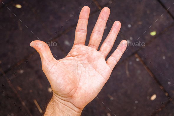 Small man's hand, open and top view, isolated on black background ...
