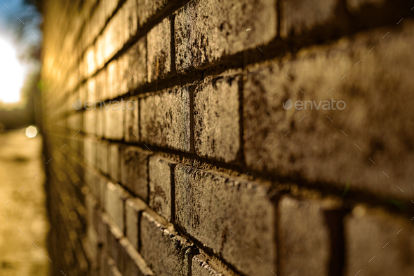 Brick wall background at sunset with sun rays, stone texture. Stock ...
