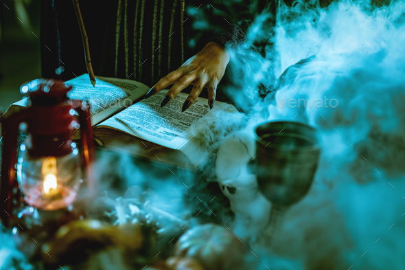 Witch's Hand On Magic Book Stock Photo by micens | PhotoDune