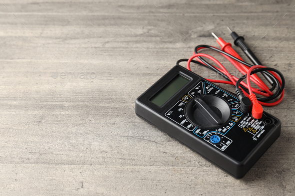 One black multimeter on gray textured background Stock Photo by ...