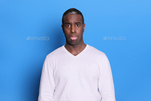 Image of sad sorrowful black man looks at camera with miserable ...