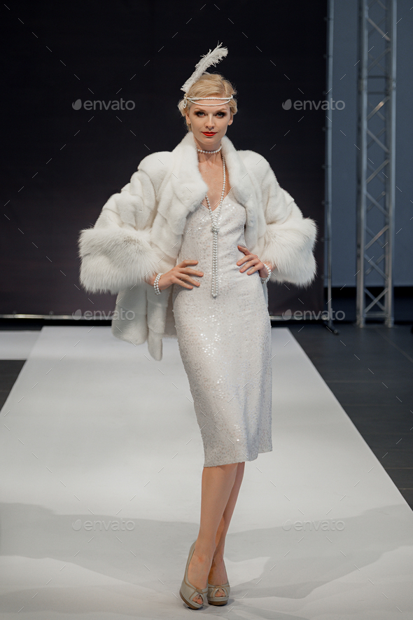 Beautiful fashion model on runway in fur coat and evening dress Stock ...