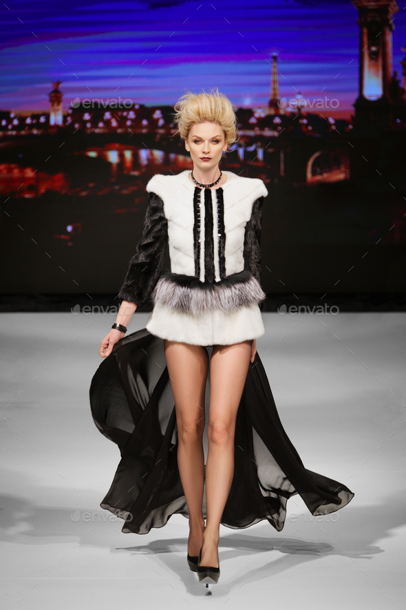 Fashion model walks on runway in fur coat at GNL show Fall-Winter 2016 ...