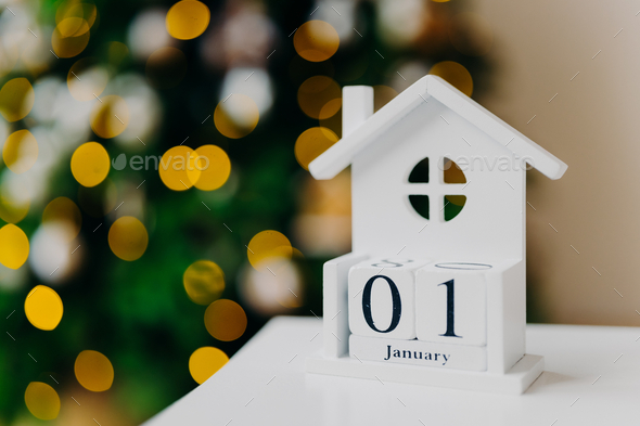 White house with written date against New Year background, tree with ...