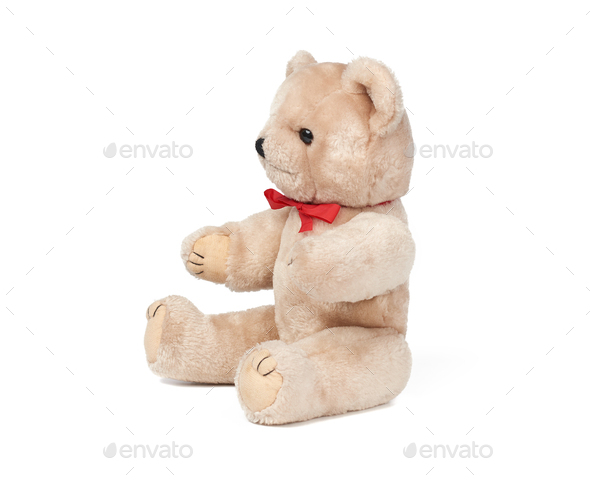 Small brown teddy bear sits on a white isolated background Stock Photo ...