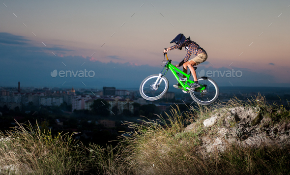 Cyclist riding downhill on mountain bike on the hill Stock Photo by ...