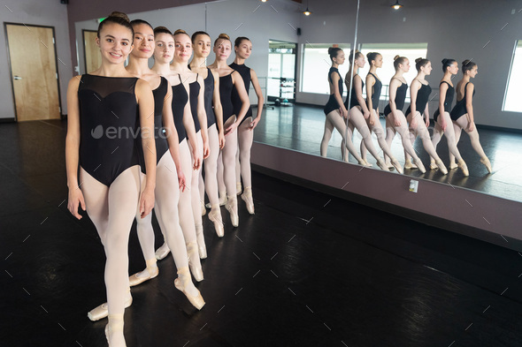 Group of seven ballet dancers standing together in dance studio Stock ...