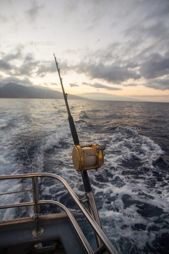 Deep Sea Fishing Reel on a boat during sunrise Stock Photo by MatHayward