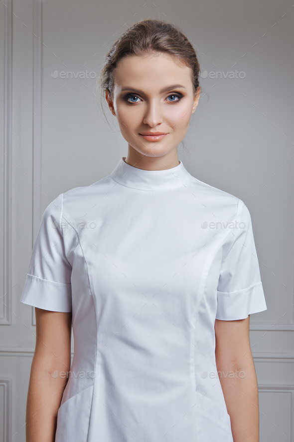 Beautiful female doctor in white clothes. Portrait of attractive medic ...