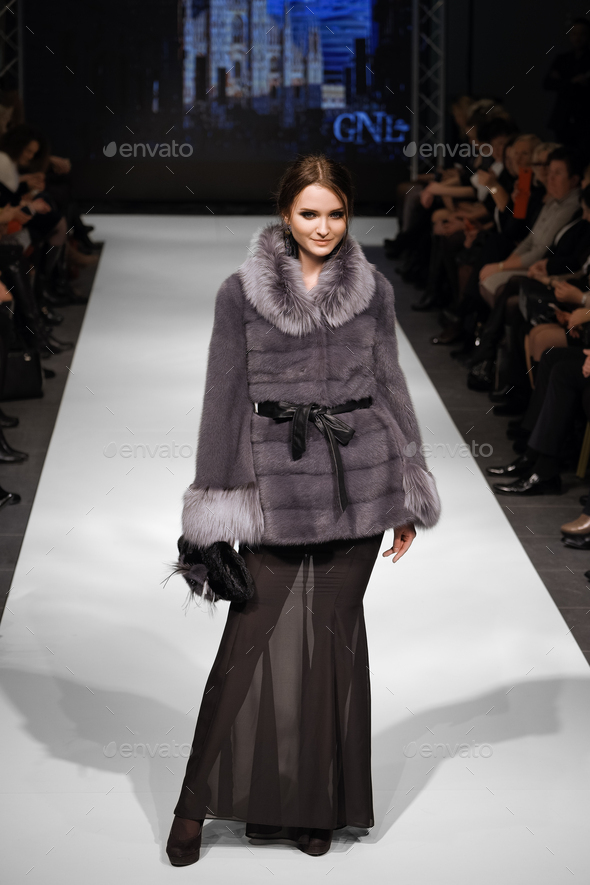 Fashion model walks on runway in fur coat at GNL show Fall-Winter 2016 ...
