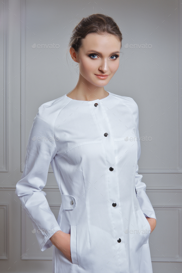 Beautiful female doctor in white clothes. Portrait of attractive medic ...