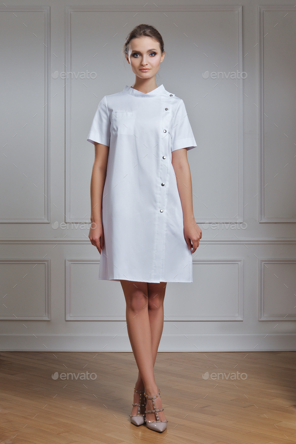Beautiful female doctor in white clothes. Portrait of attractive medic ...