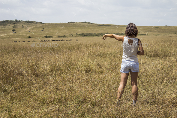 A young girl pointing at animals in the Masai Mara. Kenya Stock Photo ...