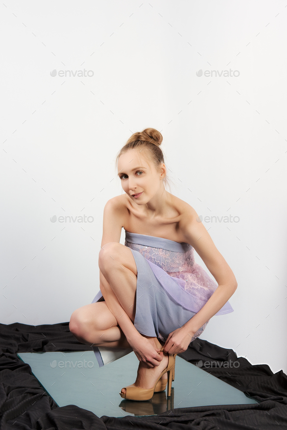 Attractive girl fasten her shoes Stock Photo by boomeart | PhotoDune