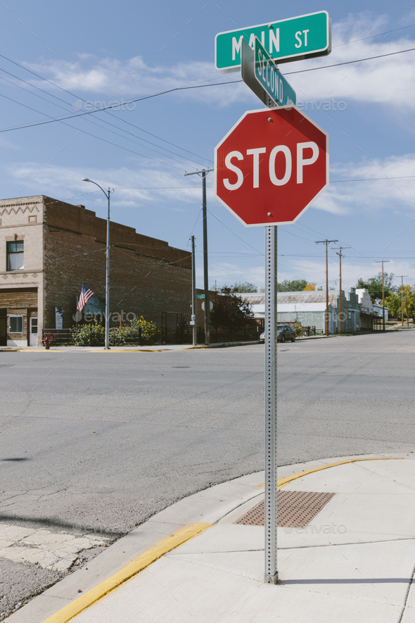 Stop sign at an intersection in a small town. Stock Photo by Mint_Images