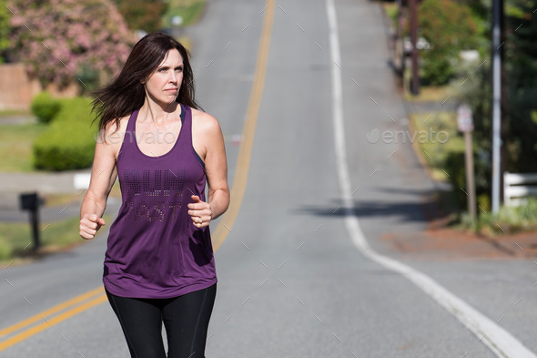 Strong woman running uphill Stock Photo by MatHayward | PhotoDune
