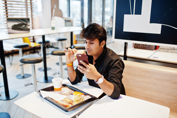Indian man at fast food cafe Stock Photo by ASphotostudio | PhotoDune