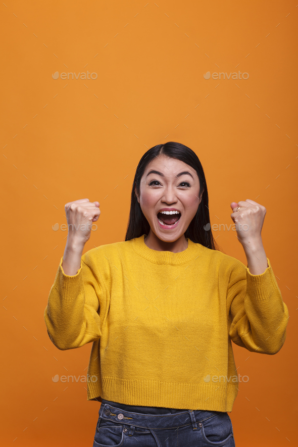 Overjoyed excited confident beautiful woman model celebrating in ...