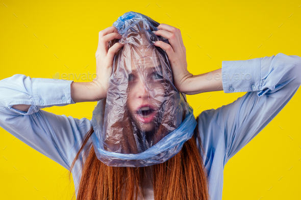 redhaired ginger european woman suffocation head in blue polyethylene ...