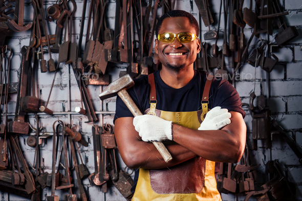 handsome african american blacksmith male worker working in workshop ...
