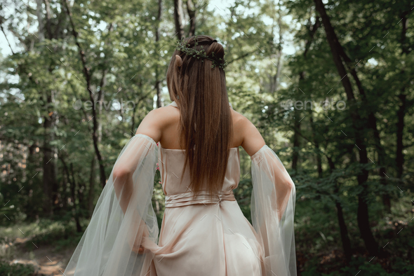 back view of mystic elf in elegant dress in forest Stock Photo by ...