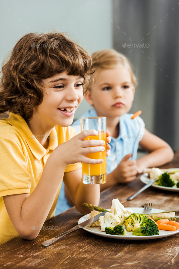 cute little kids eating healthy vegetables, smiling boy drinking juice ...