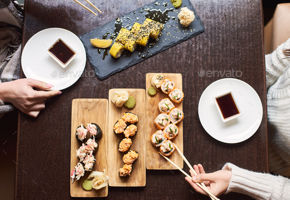 Friends eating japanese dish from rice and seafood. Stock Photo by ...