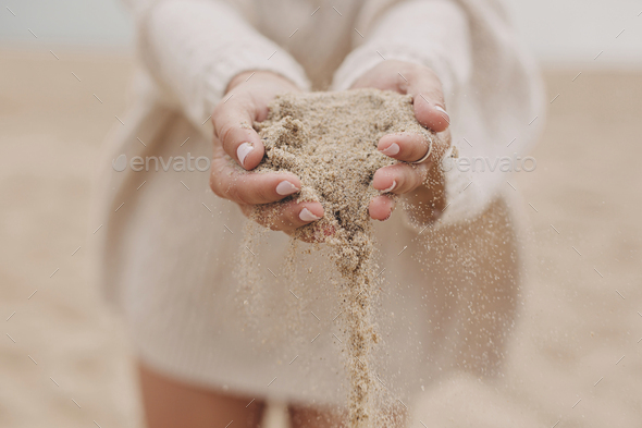 Summer beach and vacation. Hands holding sand on background of beach ...