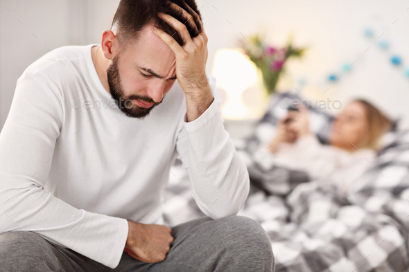 Adult attractive couple in bed having problem Stock Photo by macniak