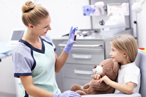Brave little girl having blood collection for tests Stock Photo by macniak