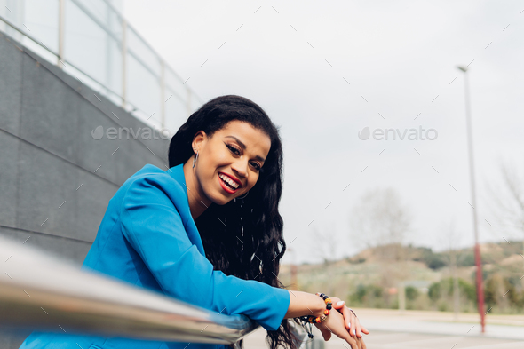 Cheerful black woman leaning on railing Stock Photo by DaniDG_ | PhotoDune