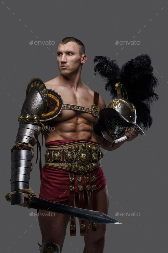 Glorious gladiator with gladius and helmet isolated on grey Stock Photo ...