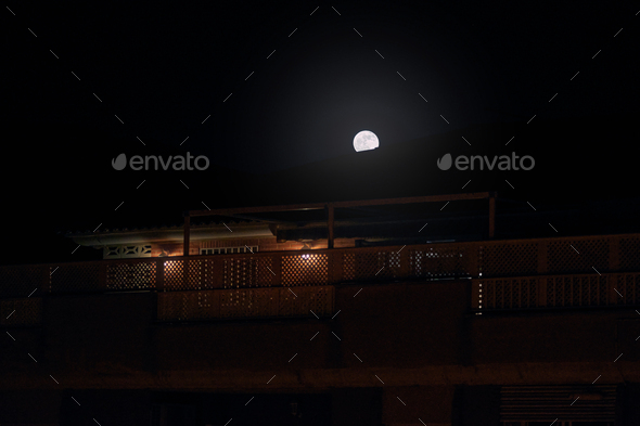 View of the moon and lighthouse from a balcony at night Stock Photo by ...