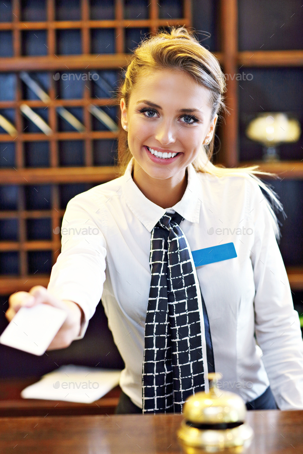 Pretty receptionist giving key card Stock Photo by macniak | PhotoDune